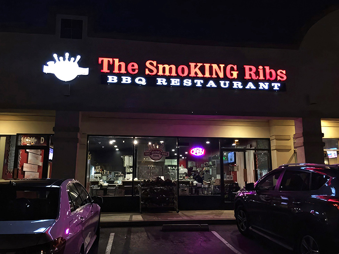 By night, the glowing red sign beckons hungry travelers like a smoky lighthouse guiding ships to delicious harbor.