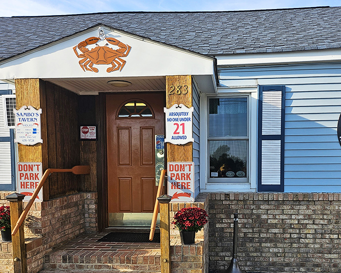 The iconic orange crab welcomes you to Sambo's Tavern, where "DON'T PARK HERE" signs are as much a part of the charm as the seafood inside.