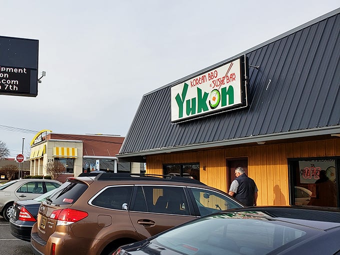 The unassuming yellow exterior of Yukon Korean BBQ & Sushi Bar stands like a beacon of culinary promise amid Dover's commercial landscape.