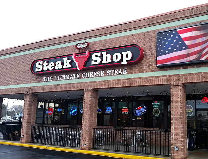 The unassuming brick exterior of Pete's Steak Shop promises no frills—just the "Ultimate Cheese Steak" that delivers on every savory syllable.