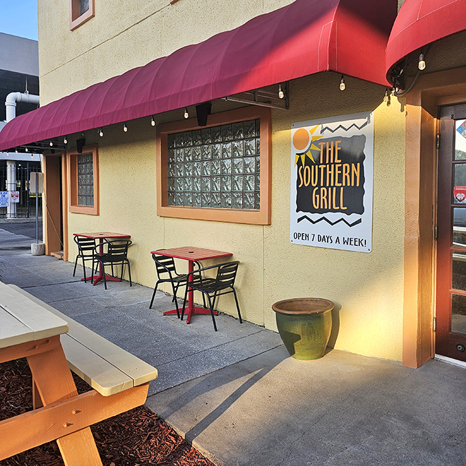 Like finding a treasure map disguised as a postcard, The Southern Grill's modest exterior with its cheerful red awning promises culinary gold within.