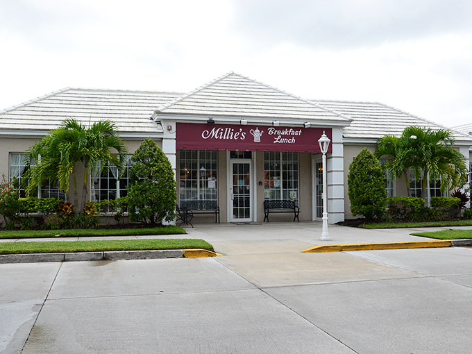 Millie's welcomes you with that perfect Florida charm – palm trees, pristine landscaping, and a burgundy awning promising breakfast bliss behind those doors.