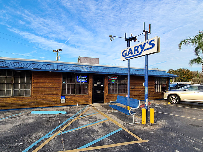 The blue-roofed wooden structure of Gary's stands proudly against the Florida sky, its no-nonsense sign promising seafood treasures within.