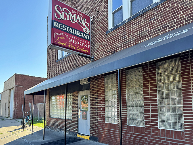 The unassuming brick exterior of Slyman's promises "the BIGGEST Corned Beef Sandwich" &ndash; not just marketing, but a solemn vow to sandwich lovers everywhere.