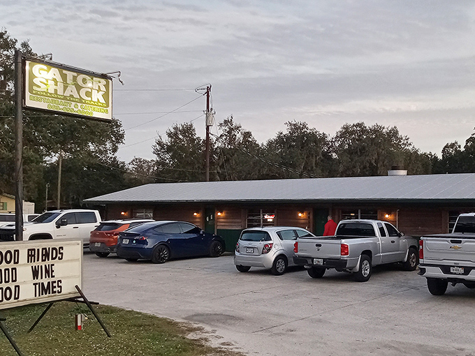 The unassuming exterior of The Gator Shack beckons with its rustic charm and a sign promising "Good Friends, Good Wine, Good Times." Florida's best secrets hide in plain sight.