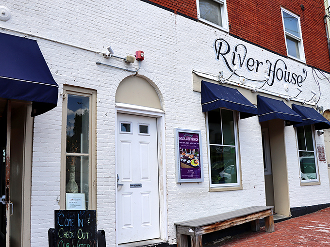The unassuming white brick fa&ccedil;ade of River House belies the seafood treasures within. Those navy awnings hint at maritime delights to come.