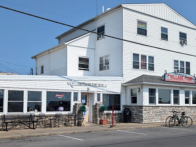 The unassuming white clapboard exterior of The Village Pump stands like a culinary lighthouse on Kelleys Island, beckoning hungry travelers with promises of Lake Erie's finest.