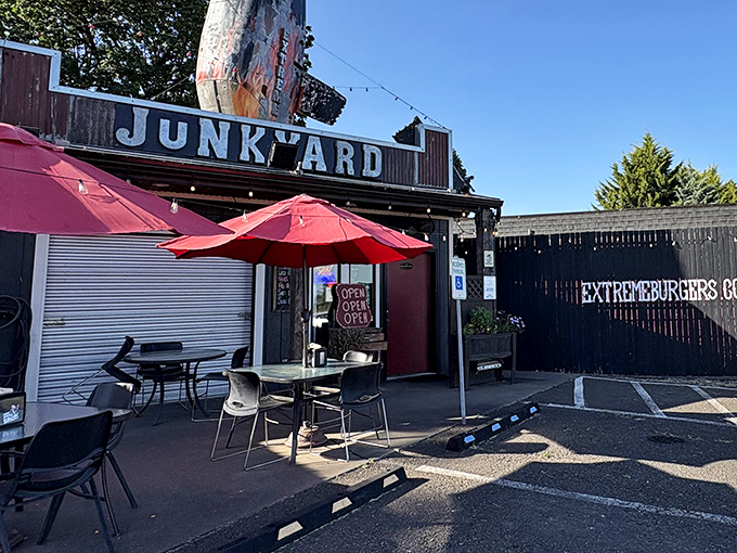 Red umbrellas beckon hungry travelers to this unassuming burger paradise where culinary dreams take flight in Junction City.
