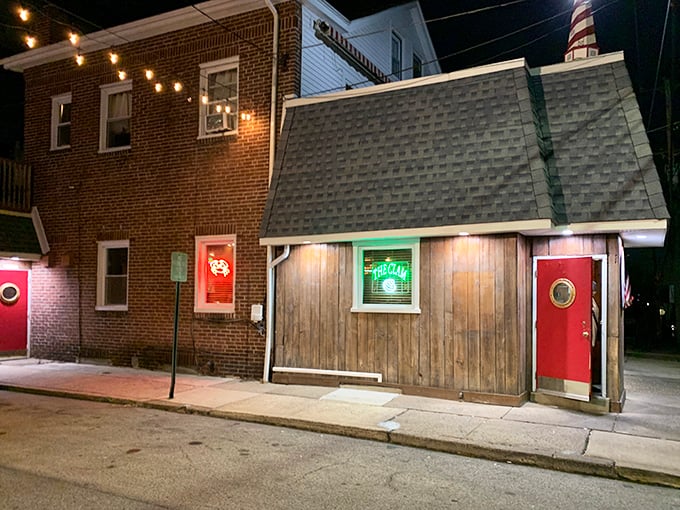 The unassuming exterior of Clam Tavern proves the old adage: never judge a seafood joint by its shingles. That red door is your portal to paradise.