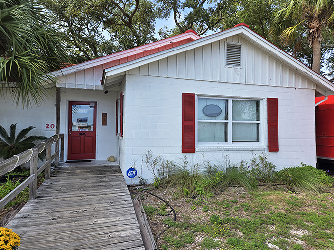 The classic white cottage with its cheerful red trim beckons seafood lovers like a lighthouse guiding hungry sailors home.