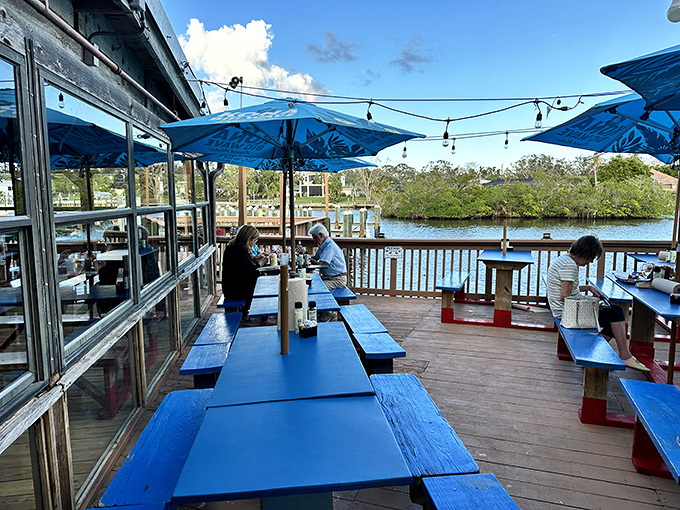 The waterfront dining experience at Phillippi Creek is like Florida's version of paradise – blue tables, gentle breezes, and seafood that makes you forget your indoor voice.