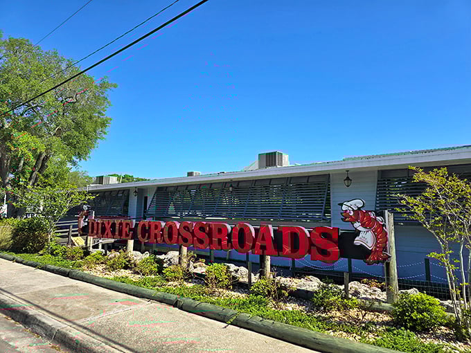 The iconic red signage of Dixie Crossroads welcomes hungry travelers like a lighthouse guiding seafood lovers safely to shore.