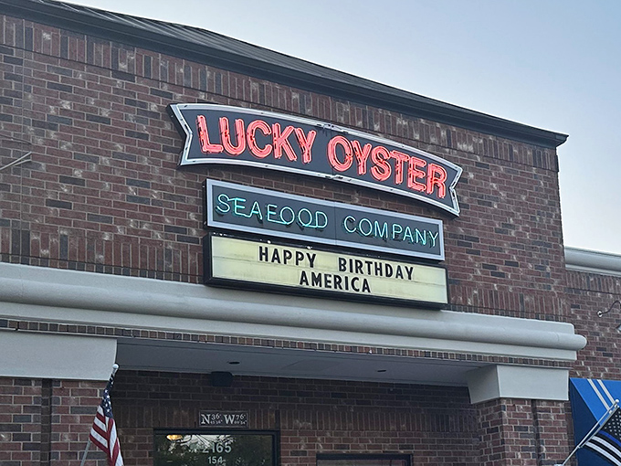 The iconic Lucky Oyster sign welcomes hungry seafood lovers like a maritime beacon. That "Happy Birthday America" message? Pure Virginia Beach hospitality. 