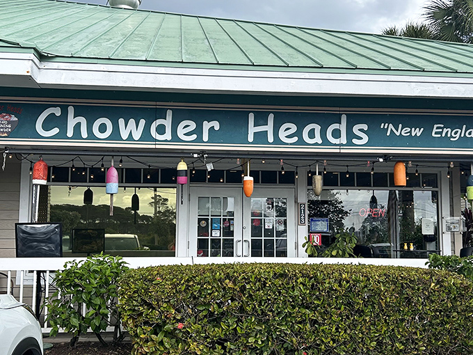 The green-roofed sanctuary of seafood salvation announces itself with colorful buoys and a promise of New England flavors that feels like a coastal hug.