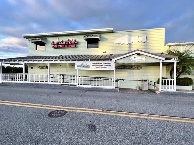 The pale yellow exterior of Aunt Catfish's welcomes you like an old friend, complete with that iconic fish silhouette promising seafood treasures within.