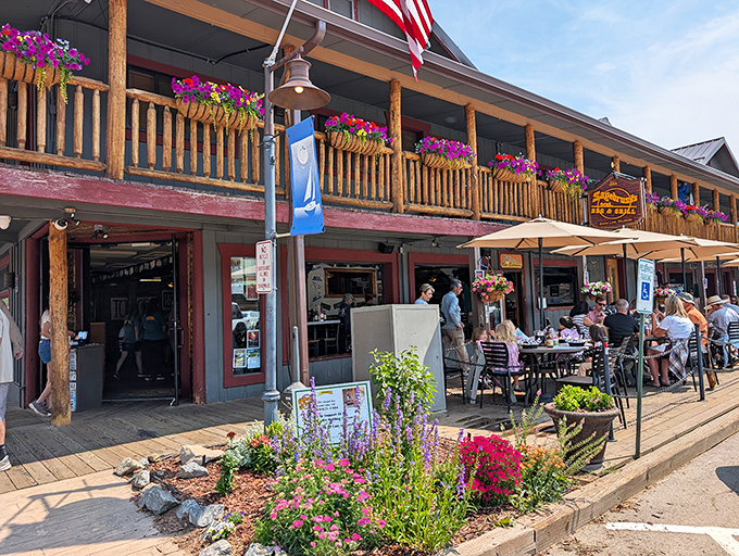 Mountain charm meets barbecue heaven at Sagebrush's inviting exterior, where hanging flower baskets and wooden beams welcome hungry travelers like old friends.