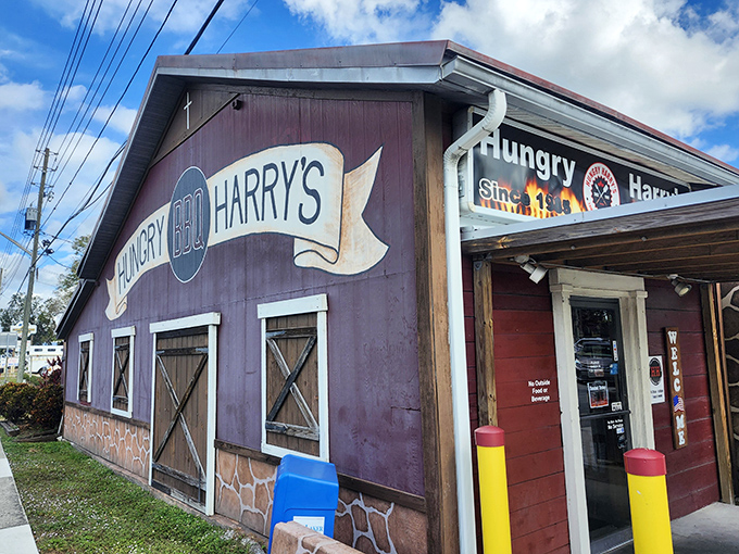 The purple barn-like exterior of Hungry Harry's stands as a beacon of BBQ authenticity. No fancy frills, just the promise of smoky deliciousness waiting inside.