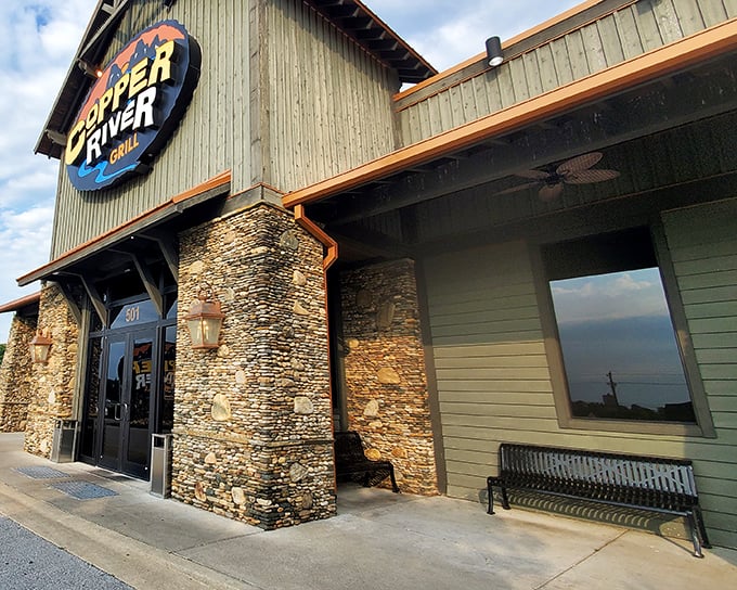 The rustic stone and timber exterior of Copper River Grill stands like a mountain lodge transplanted to Kentucky, promising warmth and hearty meals within.