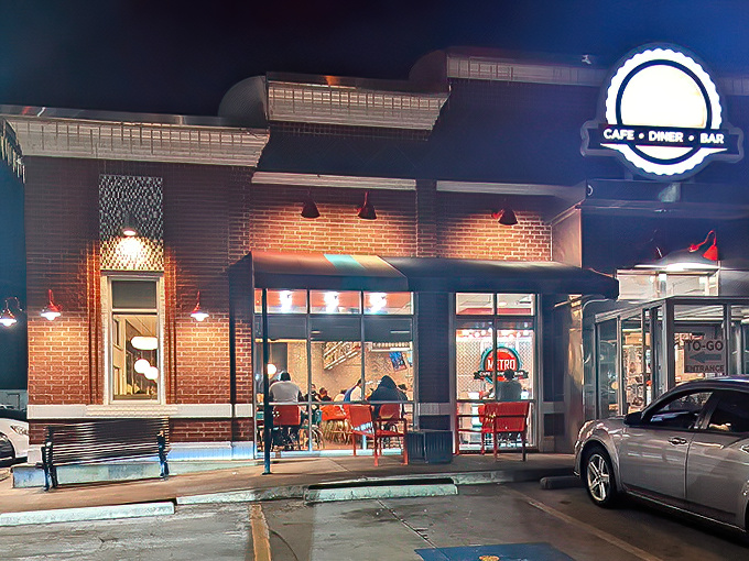 The Metro Cafe Diner glows like a beacon of breakfast hope at night, its brick exterior promising comfort food salvation for hungry souls.