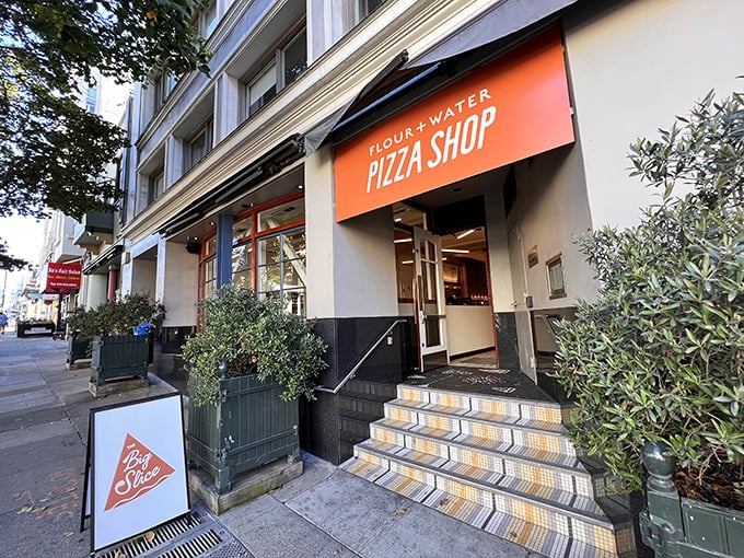 That welcoming orange awning beckons like a lighthouse for hungry souls navigating San Francisco's Mission District streets.