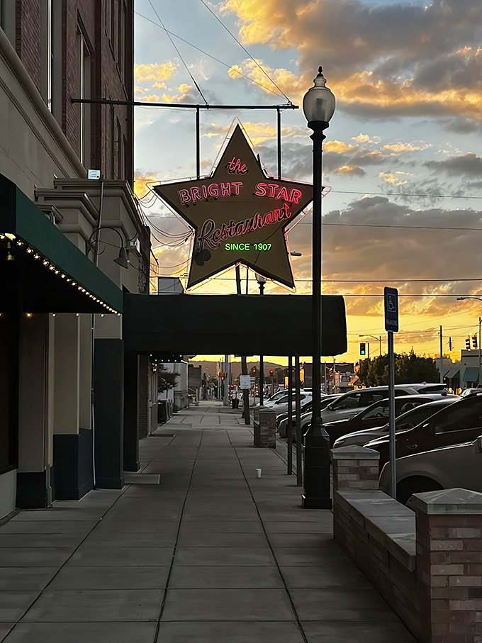 The iconic star-shaped sign glows against a sunset sky, beckoning hungry travelers like a culinary lighthouse on Bessemer's main street.