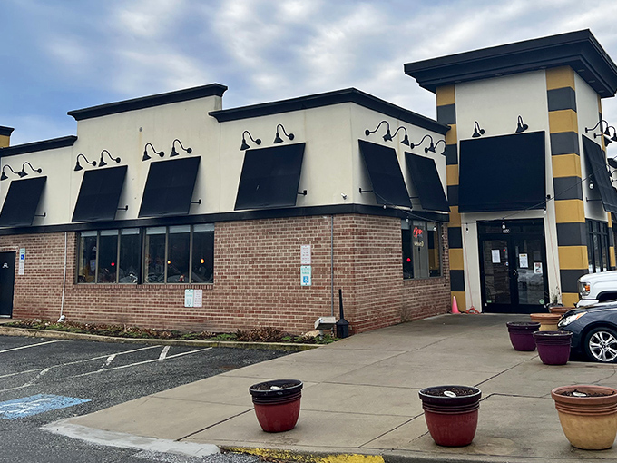 The yellow and black striped corner of Bistro 24 stands like a beacon for breakfast lovers &ndash; architectural proof that the best food experiences often hide in plain sight.