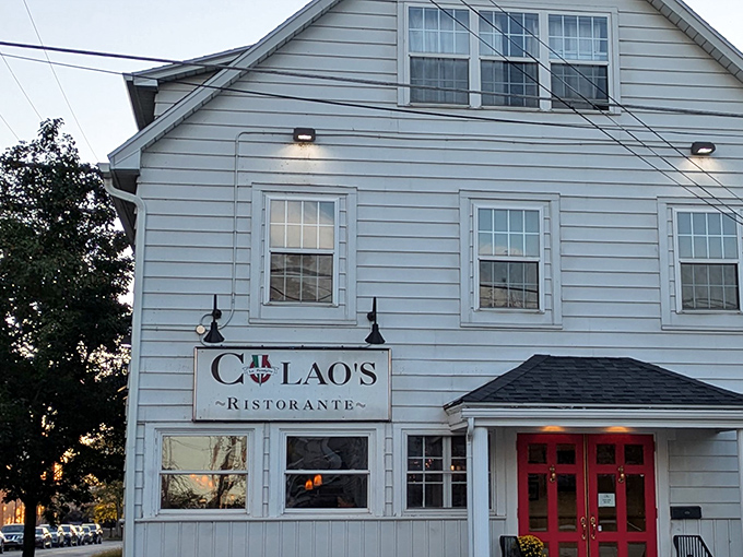 Those red doors against the white clapboard exterior aren't just an entrance &ndash; they're a portal to pasta paradise. Colao's unassuming charm hides culinary treasures within.