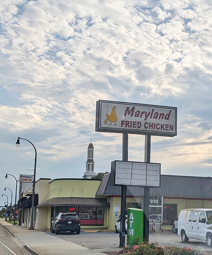 The iconic yellow building with its vintage sign stands like a beacon of comfort food under Carolina skies. No frills, just chicken thrills.