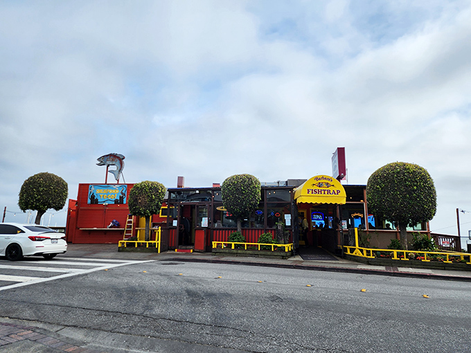 The bright yellow awning and weathered red exterior of Barbara's Fishtrap stands as a beacon for seafood lovers&mdash;no Instagram filters required for this authentic coastal gem.