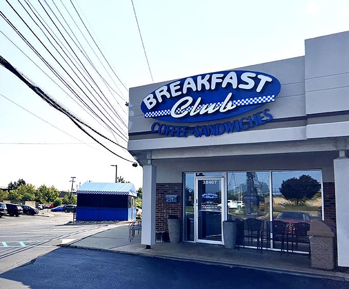 Same welcoming exterior, different angle &ndash; like seeing an old friend from a new perspective. That blue awning practically whispers "coffee's hot inside."