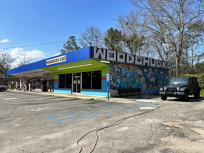 A wider view reveals the caf&eacute;'s colorful mural-adorned exterior &ndash; proof that sometimes the most vibrant culinary experiences come in unassuming packages.