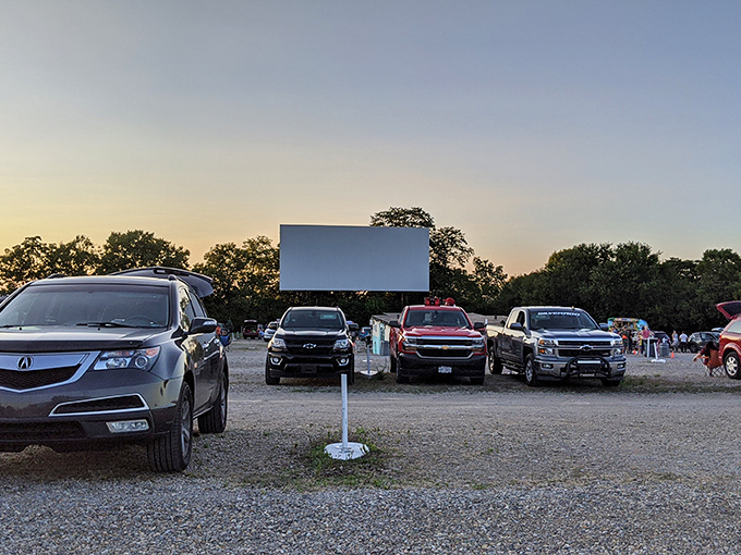 Cars lined up at twilight, a sea of anticipation as the massive screen awaits its moment to shine against an Ohio sunset.