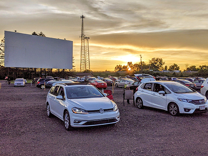 Sunset transforms the Aut-O-Rama into a golden-hued paradise where cars gather like faithful worshippers before the altar of cinema.