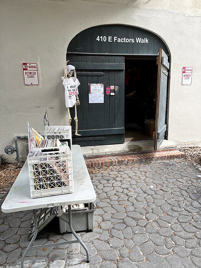 The unassuming entrance to Graveface Museum, where a skeleton doorman wearing an "I ASSURE YOU WE'RE OPEN" t-shirt welcomes the brave and curious alike.