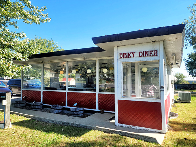 The Dinky Diner stands proudly against the Iowa sky, its red and white exterior promising comfort food treasures that would make any road-tripper slam on the brakes.