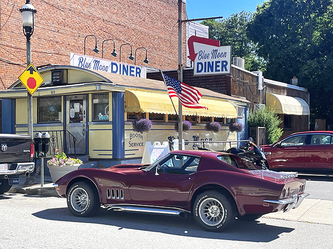 The classic American diner dream, complete with vintage signage, yellow awnings, and a classic Corvette that seems to have time-traveled from the '70s.