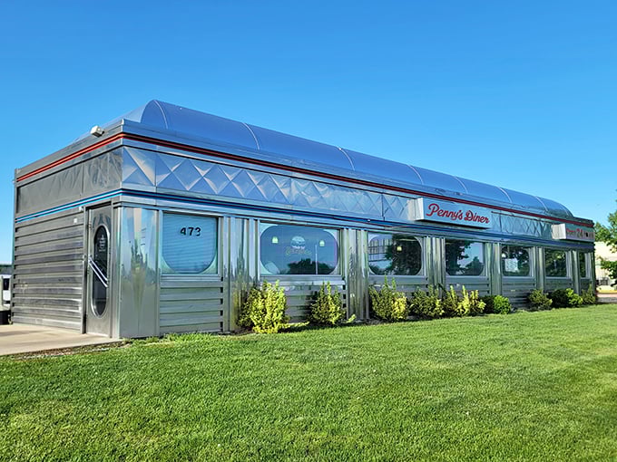 The gleaming stainless steel exterior of Penny's Diner shines like a beacon of hope for hungry travelers crossing Nebraska's heartland.