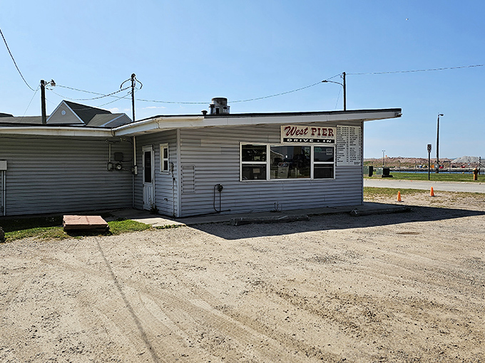 The unassuming white exterior of West Pier Drive-In stands like a culinary lighthouse in Sault Ste. Marie, beckoning hungry travelers with its simple promise of greatness.