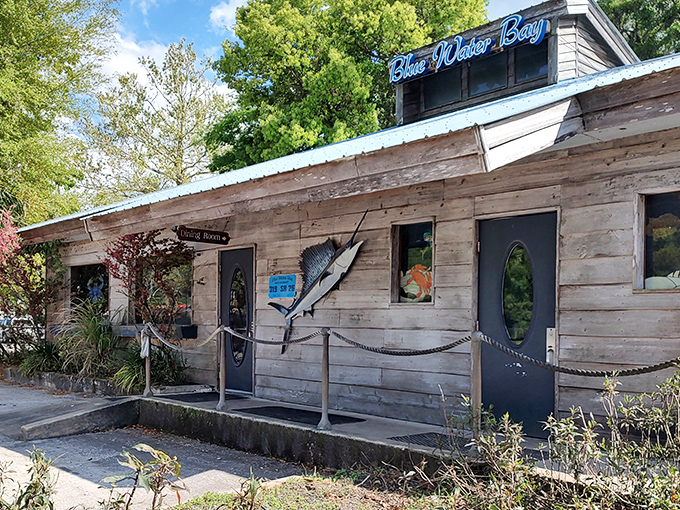 The weathered wooden exterior of Blue Water Bay might fool you, but locals know this unassuming building houses seafood treasures worth their weight in gold.