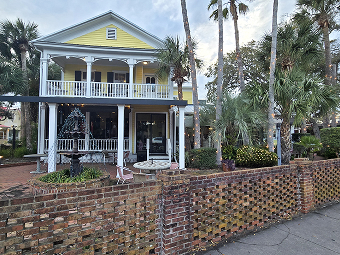 The sunshine-yellow Victorian home stands like a culinary lighthouse, beckoning hungry travelers with its wraparound porches and promise of old Florida charm.