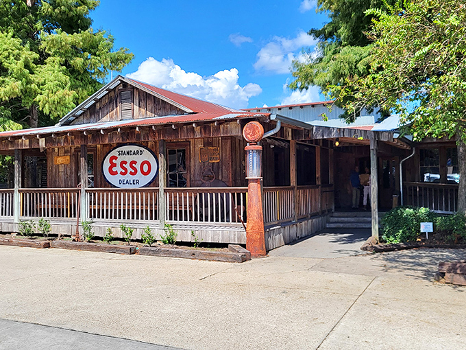 The rustic charm of Parrain's exterior, complete with vintage Esso sign, promises authentic Louisiana flavors hiding behind those weathered wooden walls.