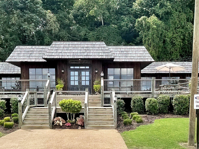 Approaching this riverside gem feels like discovering a secret fishing cabin, complete with wooden steps that have welcomed generations of catfish enthusiasts.