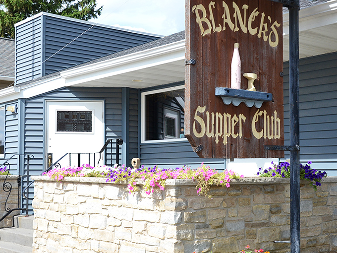 The rustic wooden sign against the blue siding says it all &ndash; this isn't fancy dining, it's Wisconsin comfort at its finest.