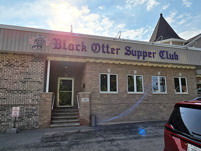 The iconic purple sign of Black Otter Supper Club welcomes hungry travelers like a beacon of hope for empty stomachs on Wisconsin's backroads.