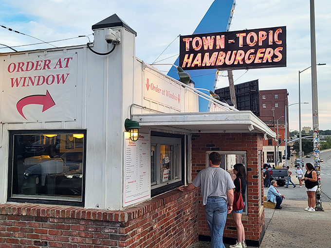 The neon beacon of burger bliss! Town Topic's iconic sign has guided hungry Kansas Citians to this humble brick-and-white diner for generations.