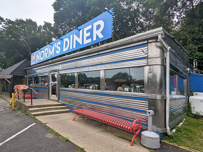 The iconic blue and silver exterior of Norm's Diner stands like a time machine on wheels, permanently parked in Groton and ready to transport you to breakfast nirvana.
