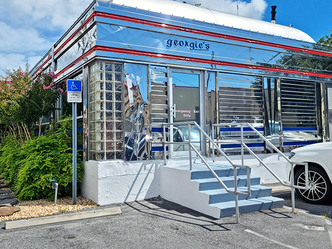 The gleaming chrome exterior of Georgie's Diner shines like a beacon of breakfast hope, complete with classic glass blocks and that unmistakable retro silhouette.