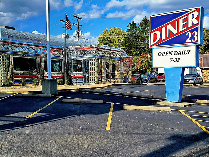Chrome dreams come true! This gleaming silver exterior with its classic curved roof and American flag stands as a shining beacon of roadside Americana on Route 23.
