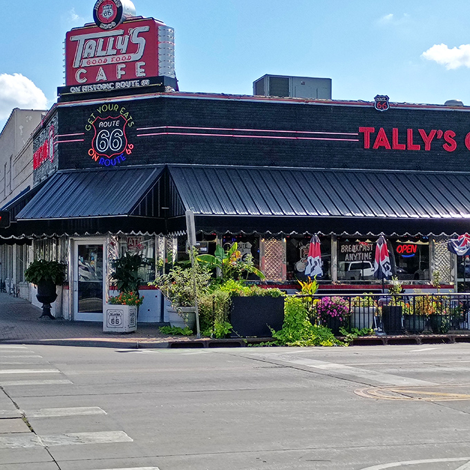 The neon-lit promise of Route 66 nostalgia beckons hungry travelers. Tally's exterior is like a time machine disguised as a diner.