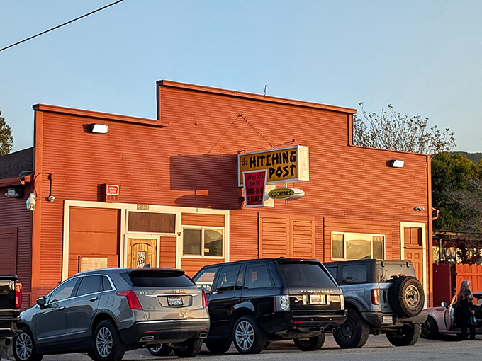 The terracotta-colored exterior of Hitching Post stands like a beacon for meat lovers, promising old-school charm and legendary steaks in the quiet town of Casmalia.